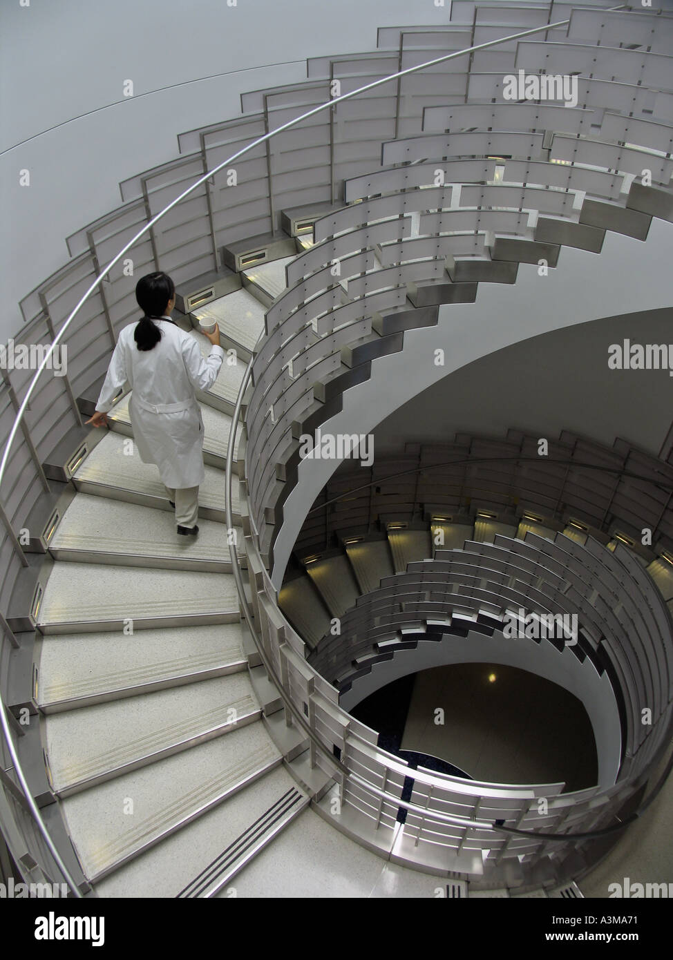 View from above of woman with long hair wearing a white laboratory coat ...