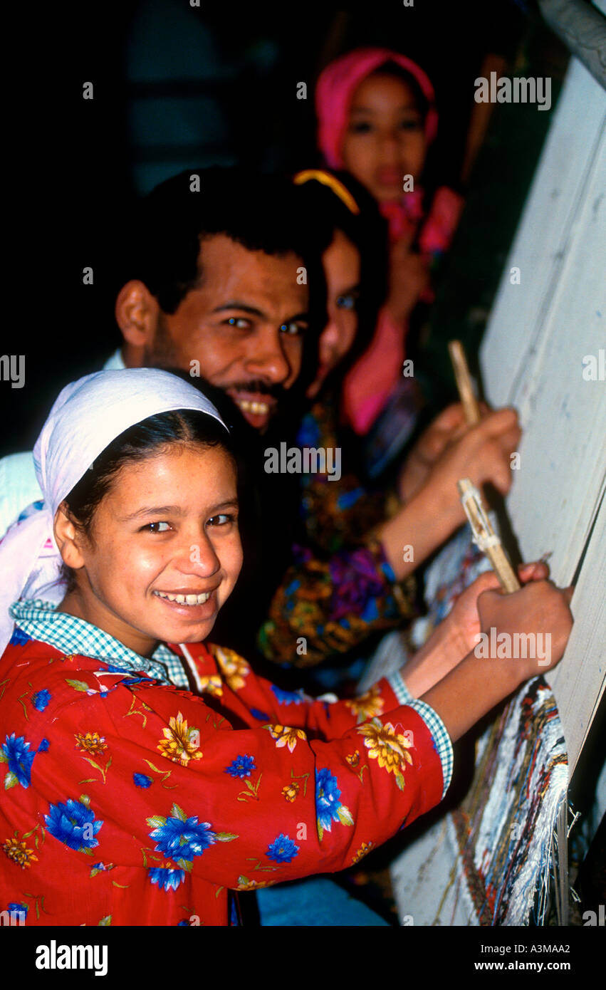 Family works at carpet loom Egypt Stock Photo - Alamy