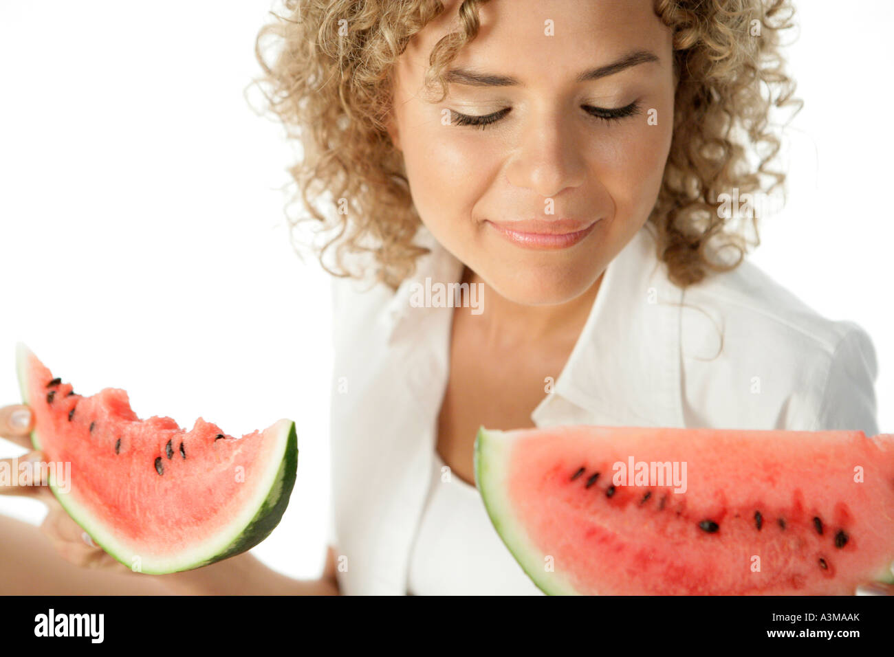 Young woman eating watermelon Stock Photo - Alamy