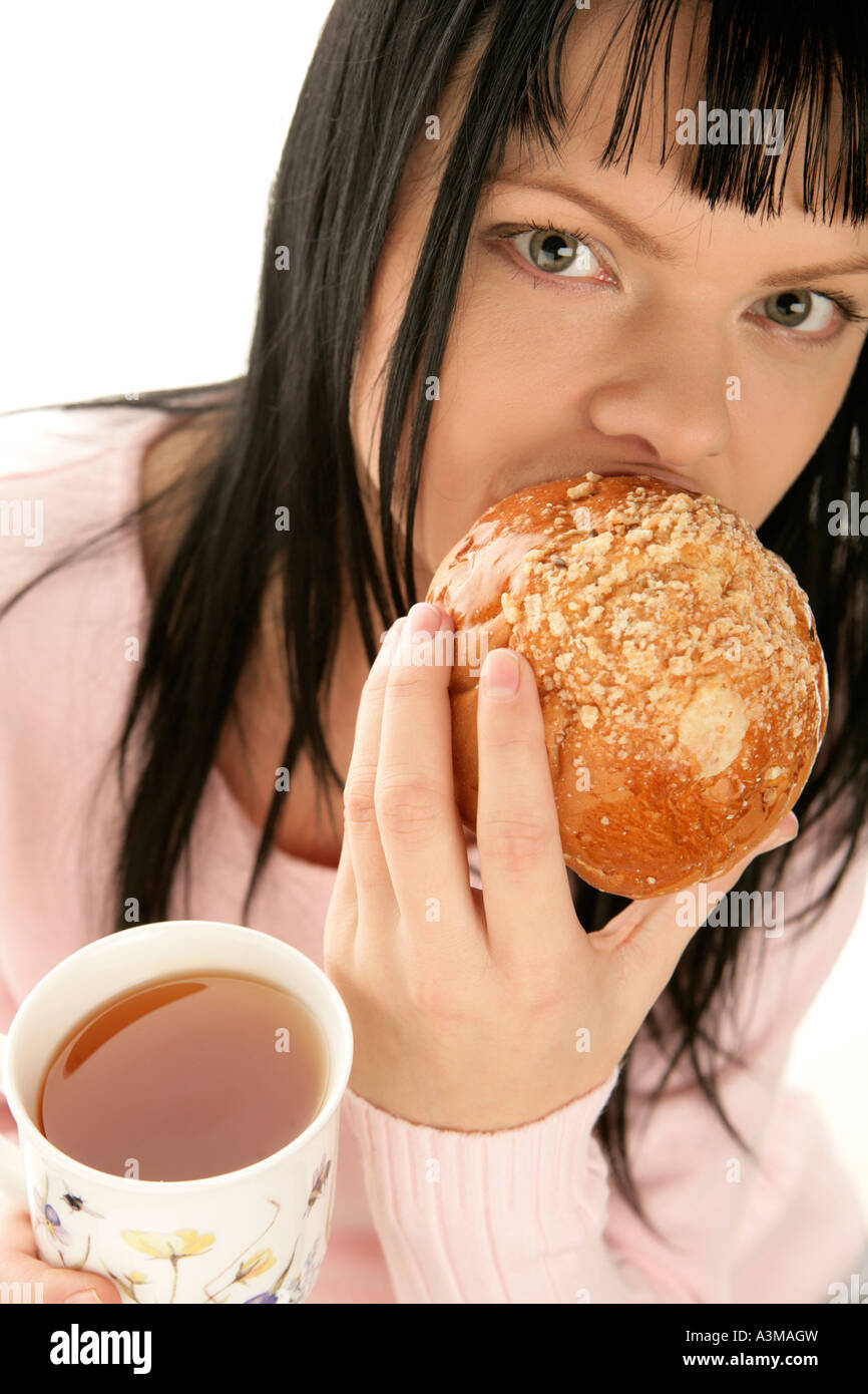 Young woman eating roll Stock Photo - Alamy