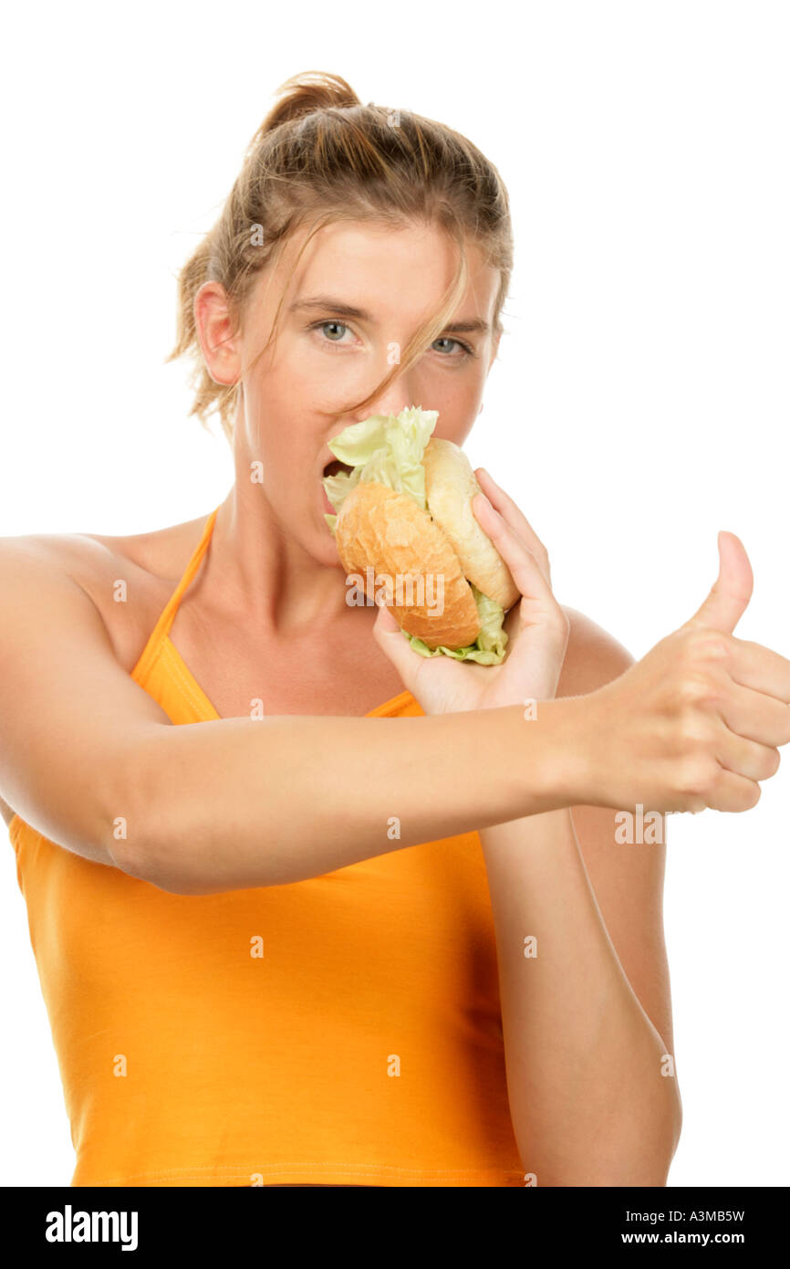 Woman eating burger and giving thumbs up Stock Photo - Alamy