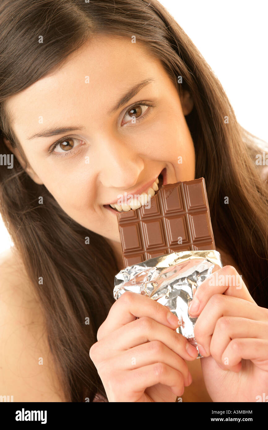 Woman eating chocolate Stock Photo - Alamy