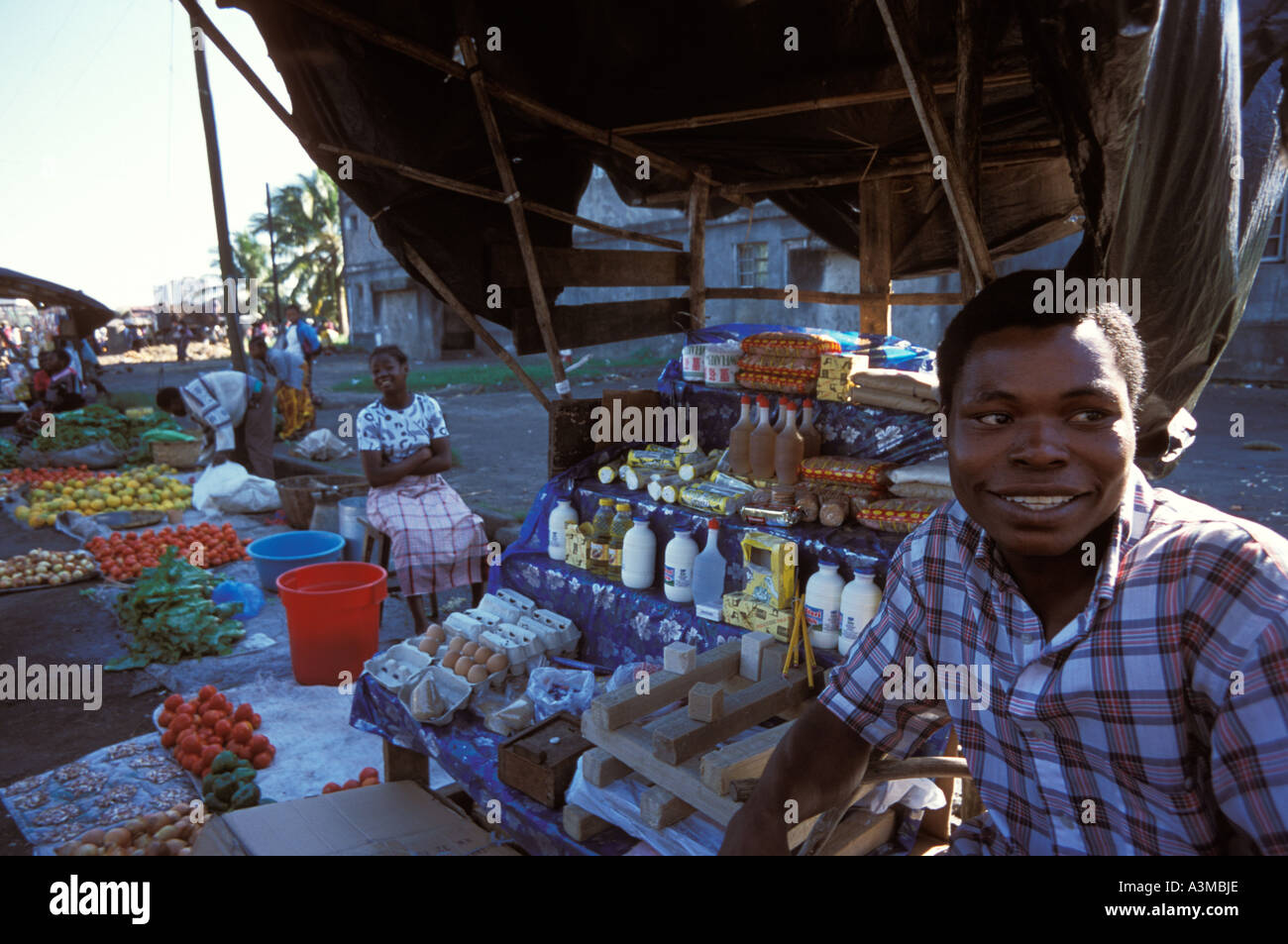 Local market vendor in Nampula Mozambique market at his kiosk or stall ...