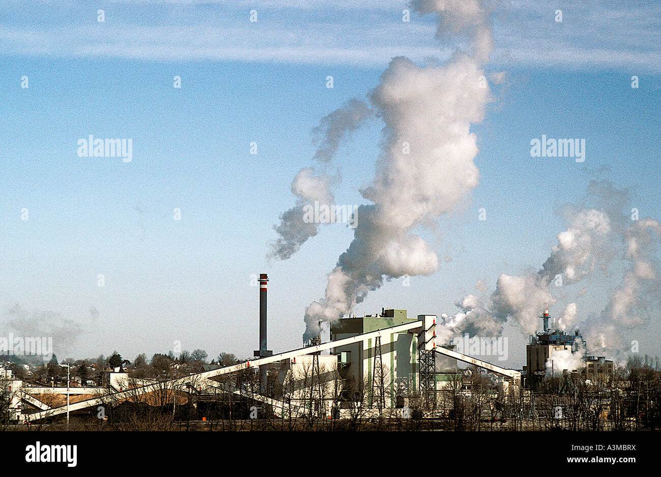 large factory billowing smoke stack smokestacks against blue sky cloud ...