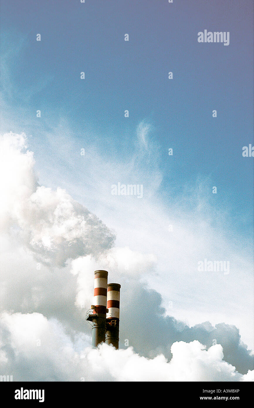 large factory billowing smoke stack smokestacks against blue sky cloud ...