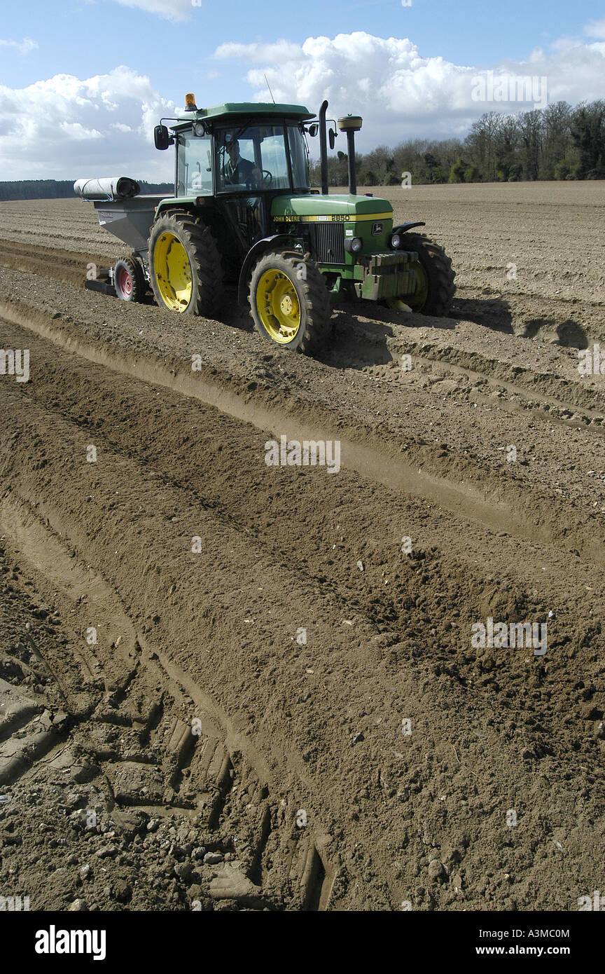 Tractor ploughing through field Stock Photo - Alamy