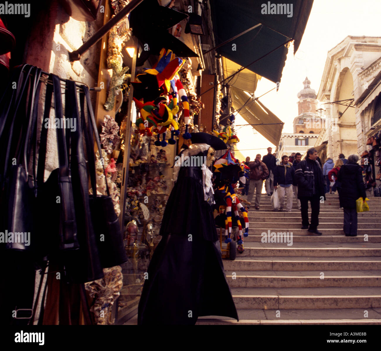 Tourists shopping and walking down the steps of the Rialto Bridge with ...