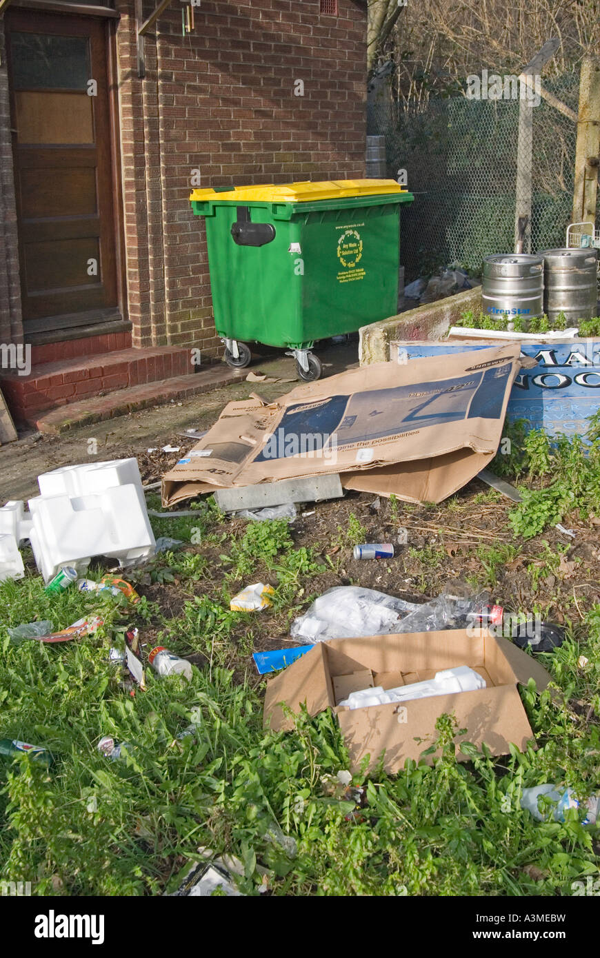 Discarded cardboard, cans, plastic, beer barrels and other rubbish by ...