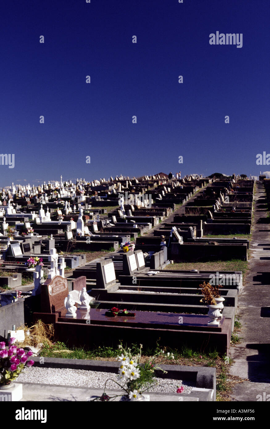 Old white and grey grave tombstones at cemetery rolling in to distance ...