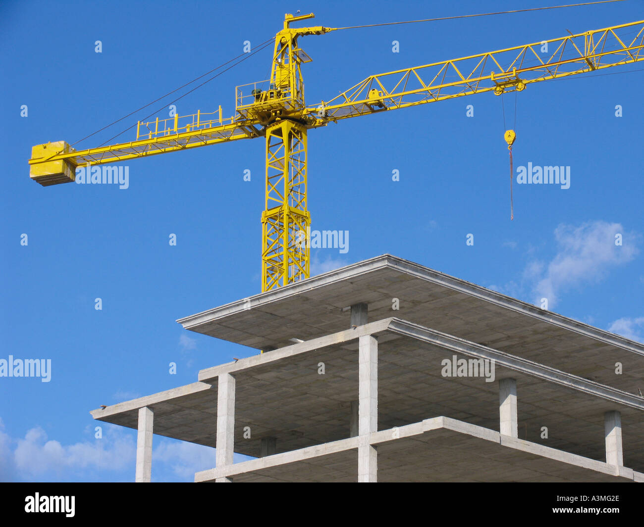 Crane over partially constructed building Stock Photo - Alamy