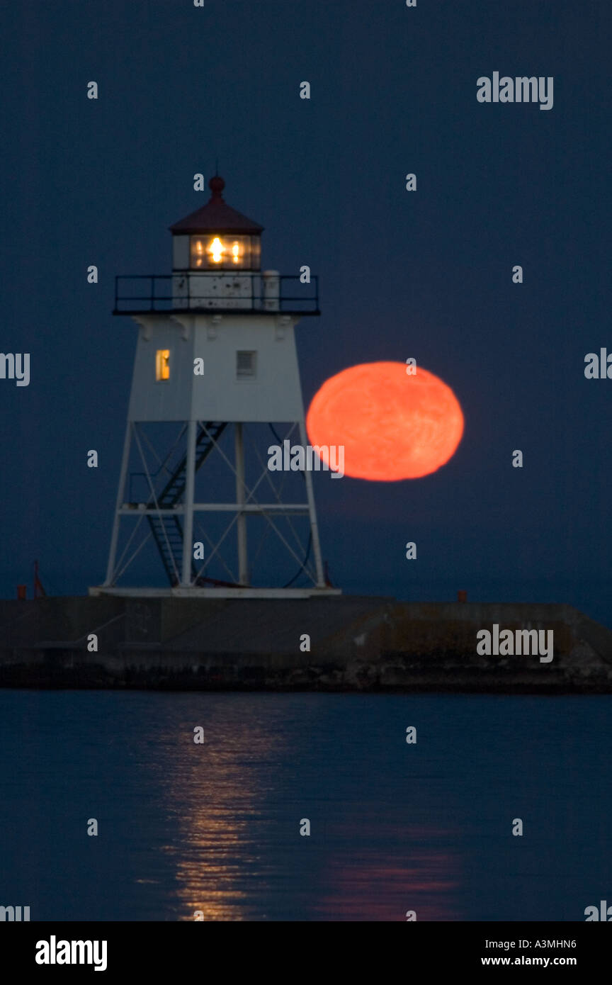 Moonrise behind the Grand Marais, MN lighthouse on Lake Superior Stock ...