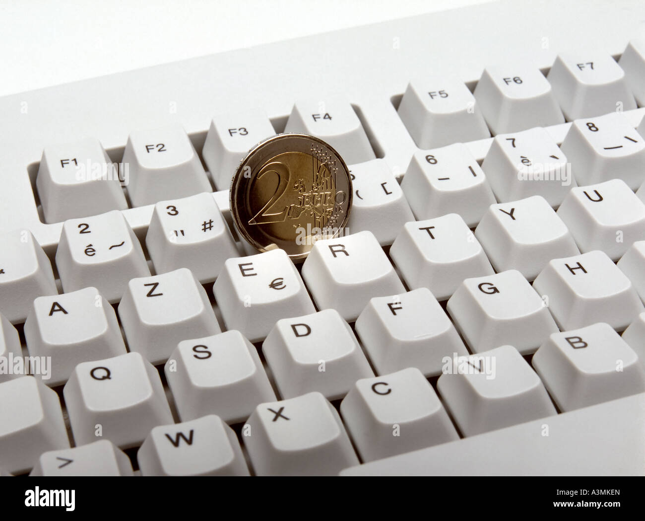 TWO EURO COIN ON COMPUTER'S KEYBOARD Stock Photo - Alamy