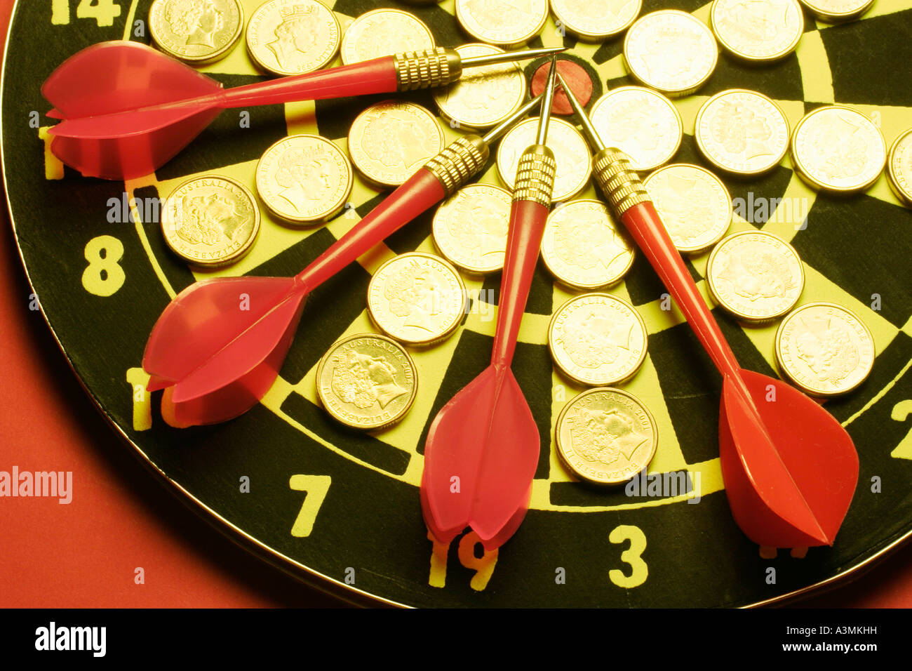 Darts and Coins on Dartboard Stock Photo - Alamy