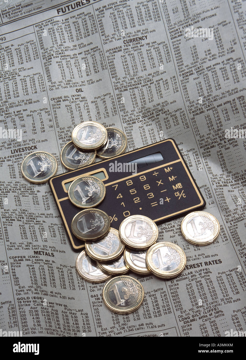 1 € EURO COINS AND CALCULATOR ON FINANCIAL PAPER Stock Photo - Alamy