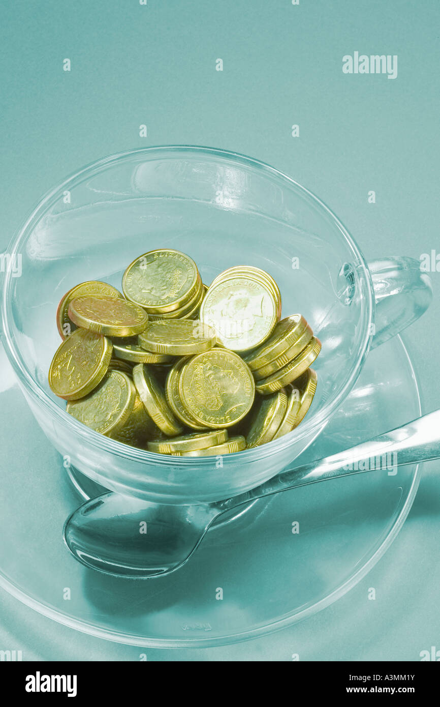 Cup and Saucer with Coins Stock Photo - Alamy