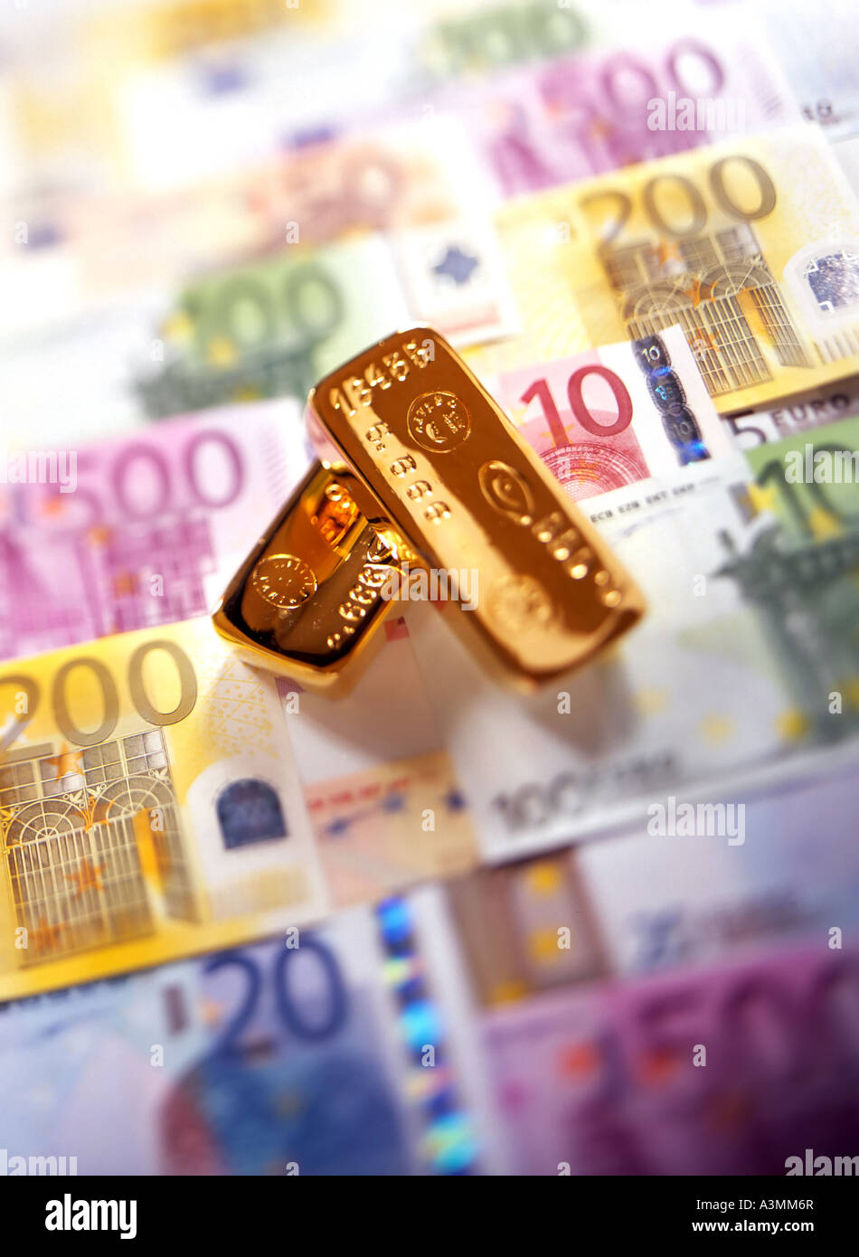 Two gold bars on Euro banknotes Stock Photo - Alamy