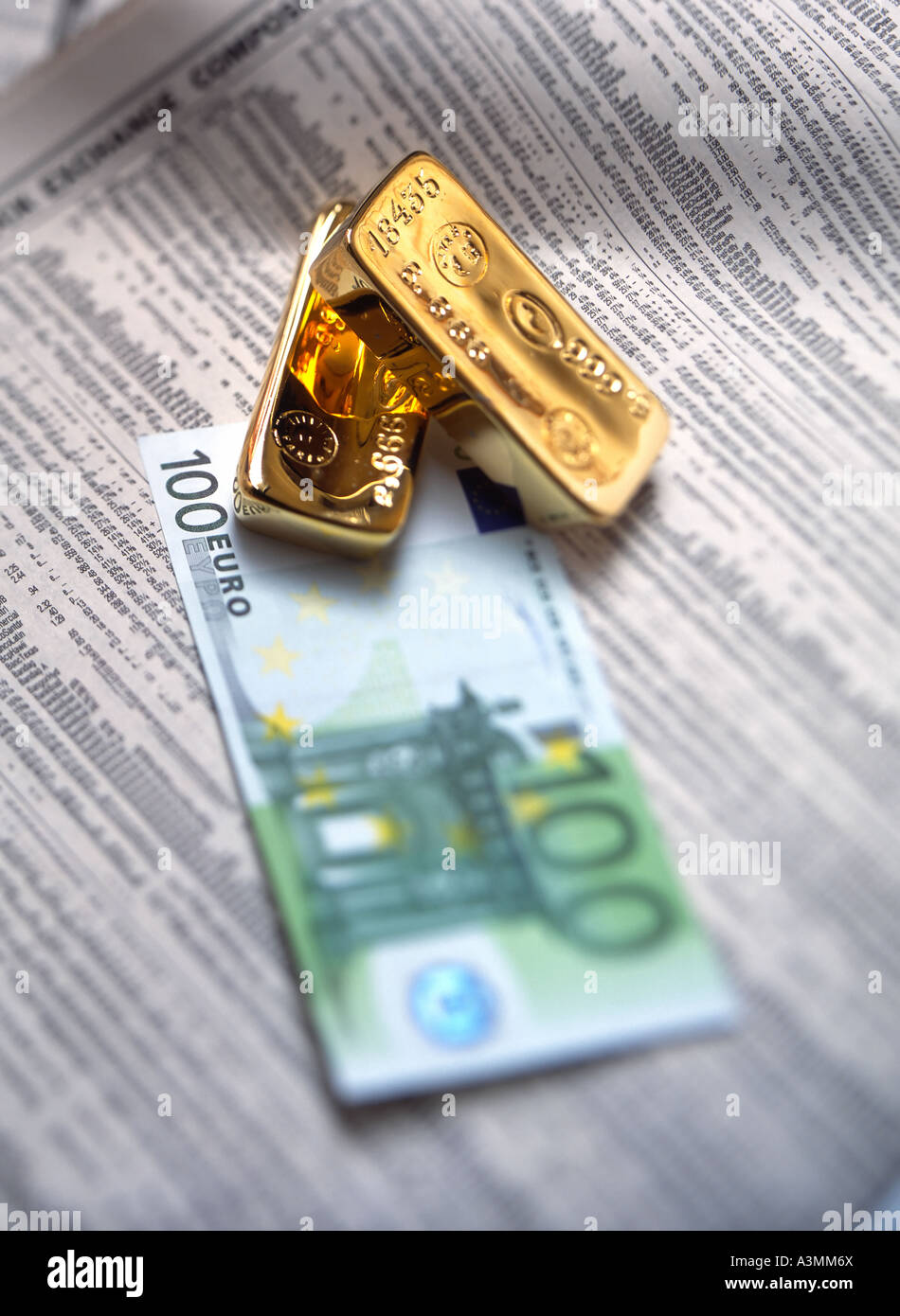 Two gold bars and 100 Euro banknote on financial paper Stock Photo - Alamy