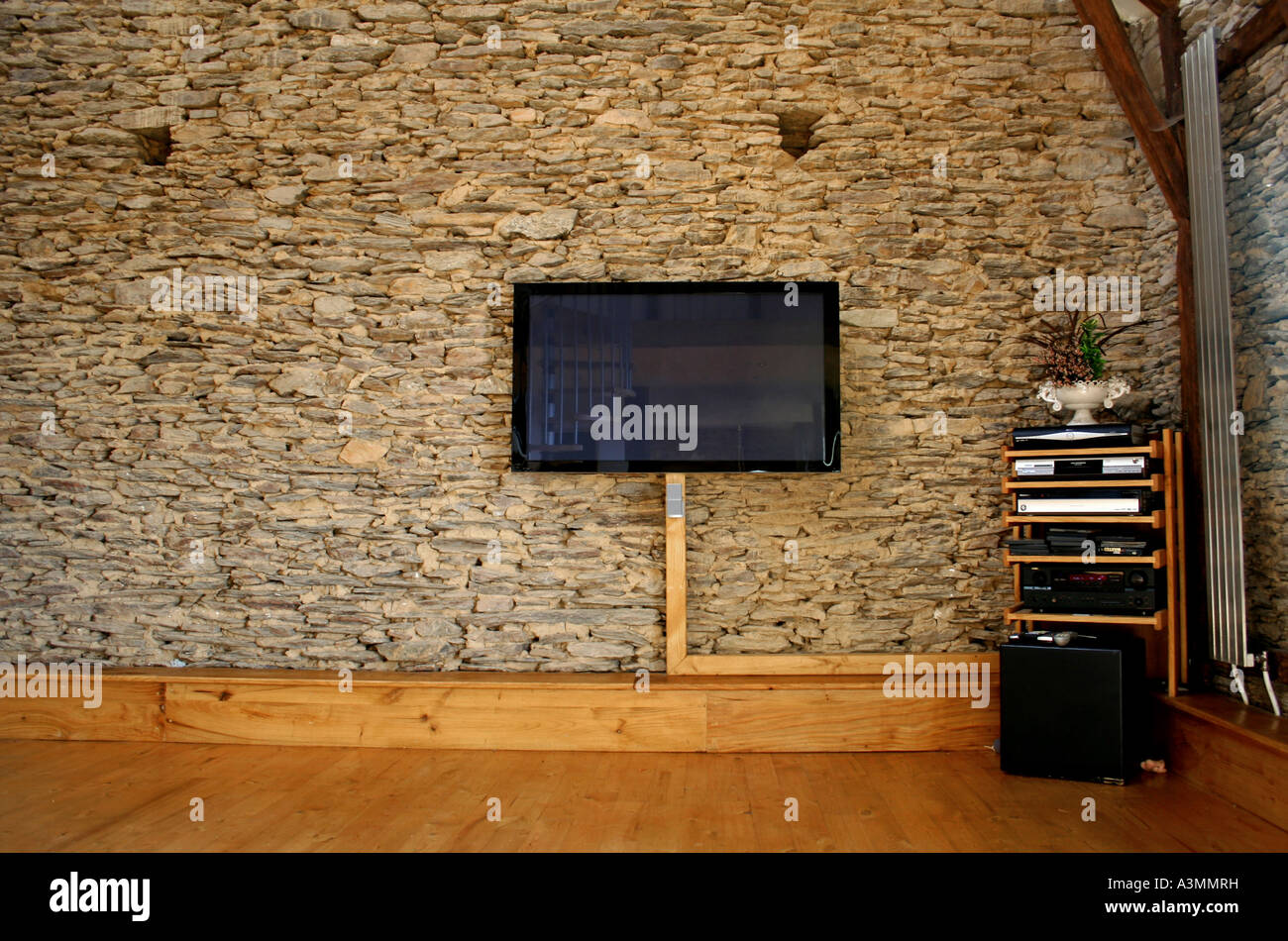 widescreen tv on stone wall Stock Photo - Alamy