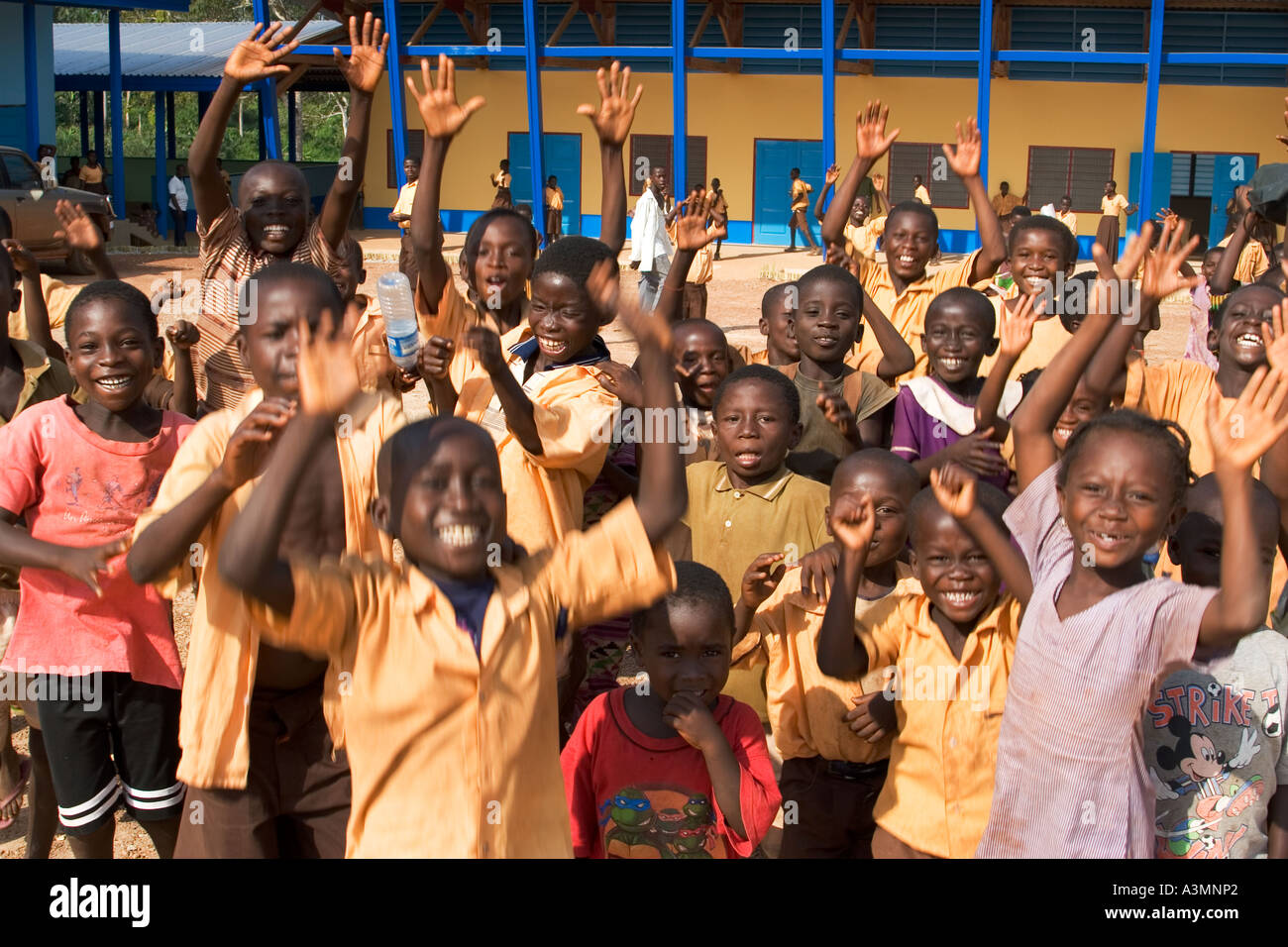 Happy smiling school children from Ghana playing, waving and cheering ...
