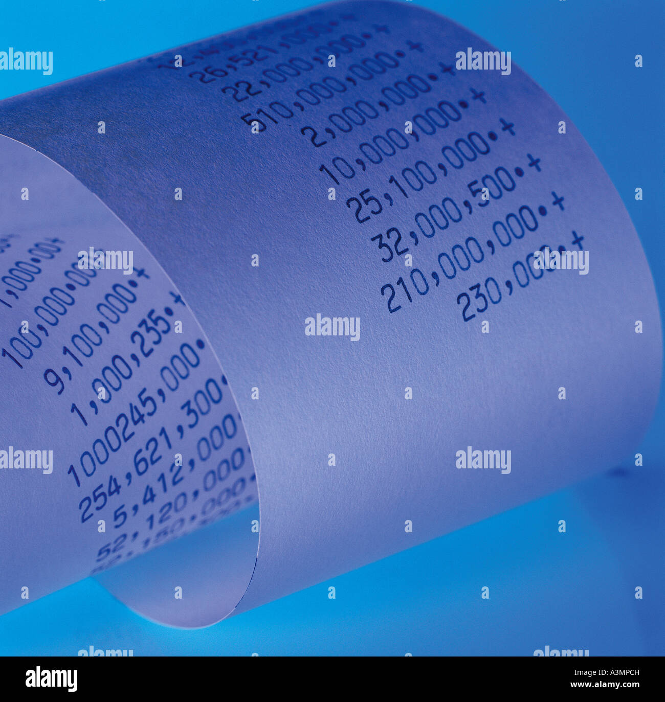 roll of calculator paper against blue lit background Stock Photo - Alamy