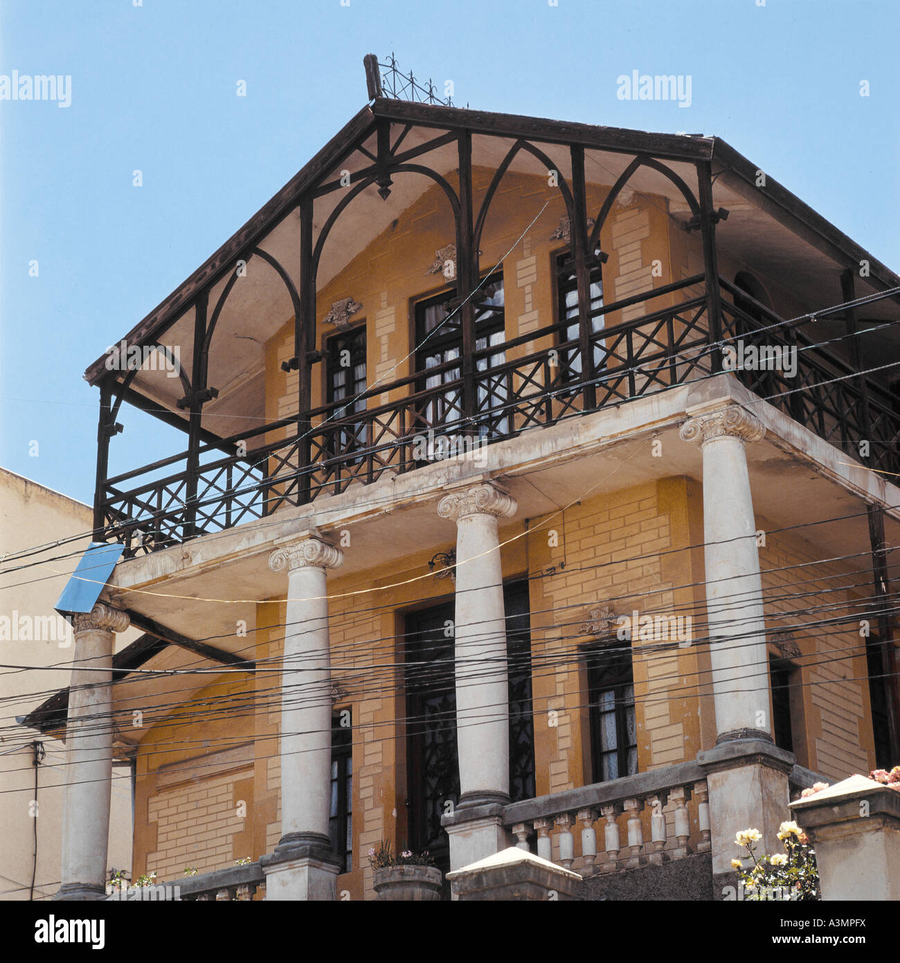Old house with upper balcony and columns below Stock Photo - Alamy
