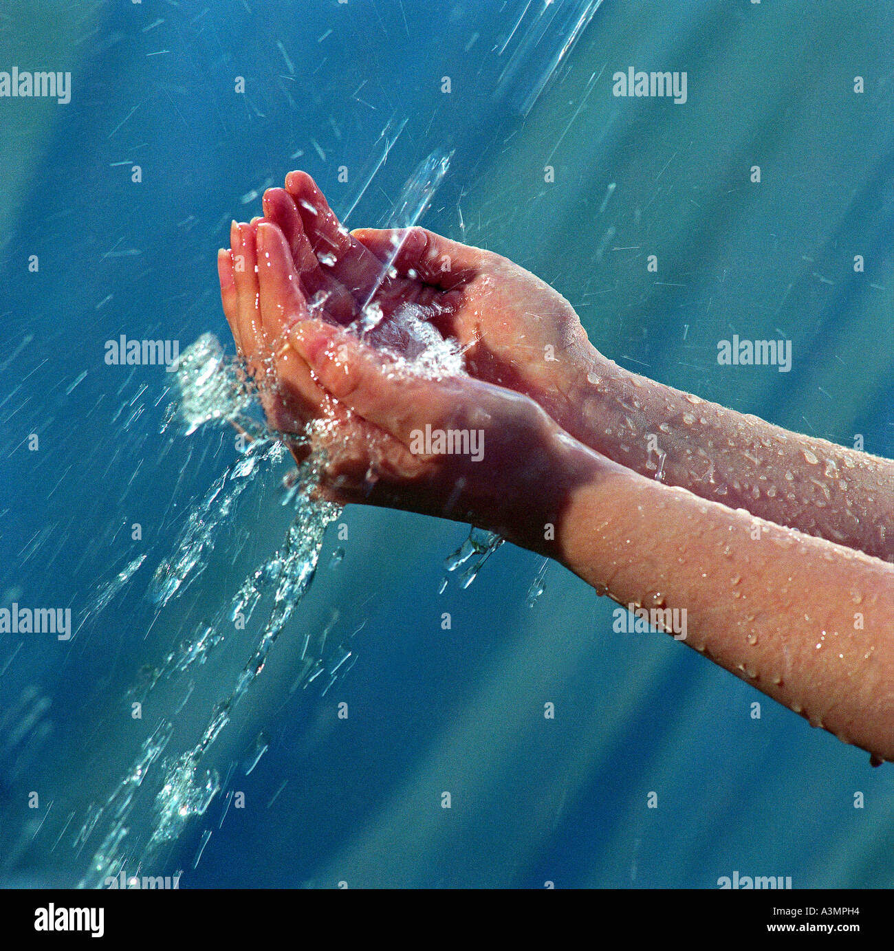 Clean water pouring and splashing into hands, UK Stock Photo - Alamy
