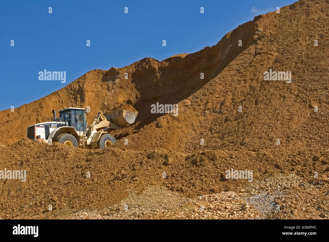 Front end loader with unprocessed sandstone and gravel from raw ...