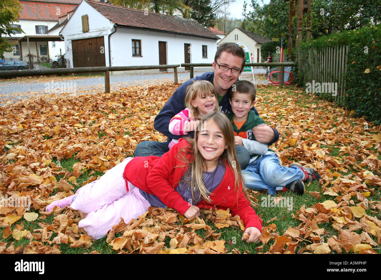 father and his three children in a park in autumn Stock Photo - Alamy