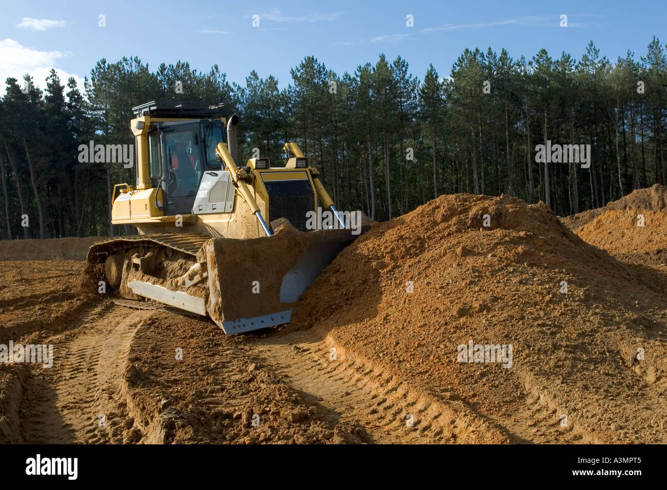 Front end loader moving top soil during land restoration. Restoring ...