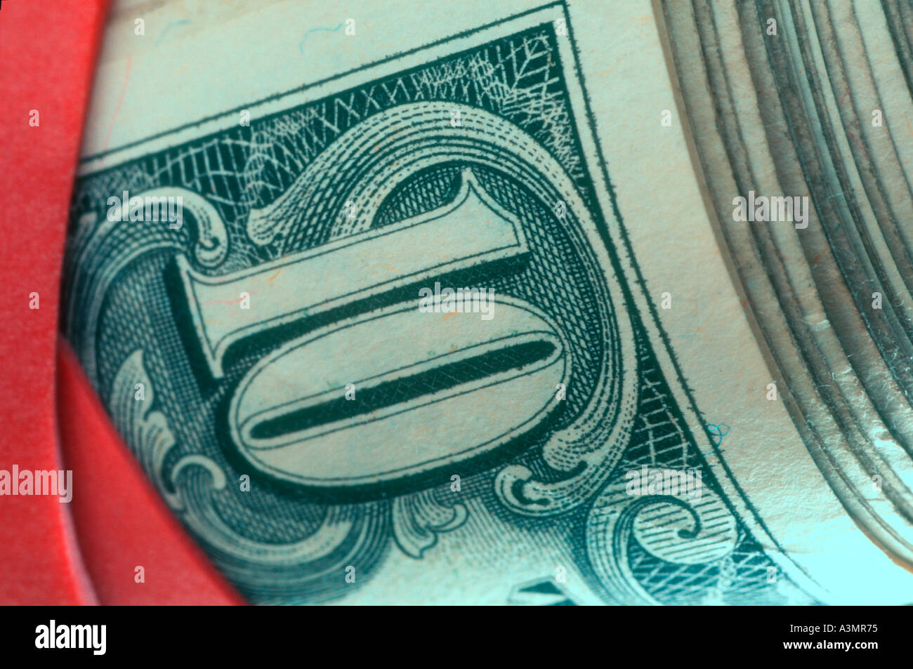 roll of ten dollar bills US and red rubber band Stock Photo - Alamy