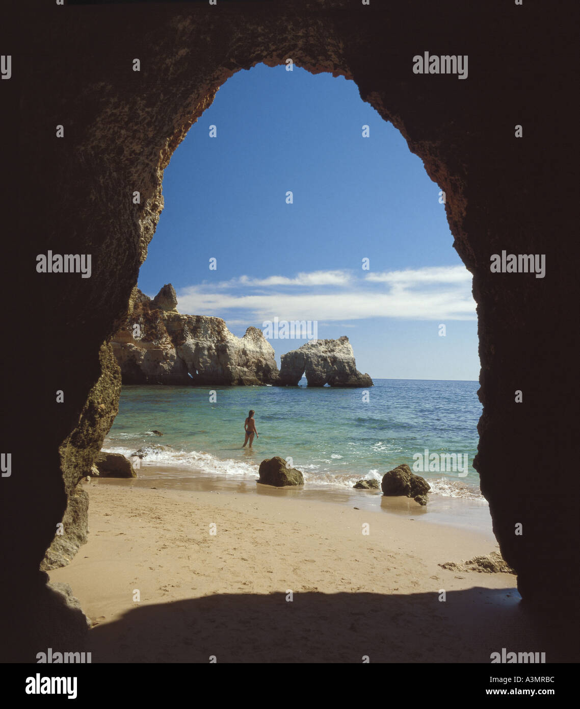 Portugal Alvor small cove view through arch in rocks Stock Photo - Alamy