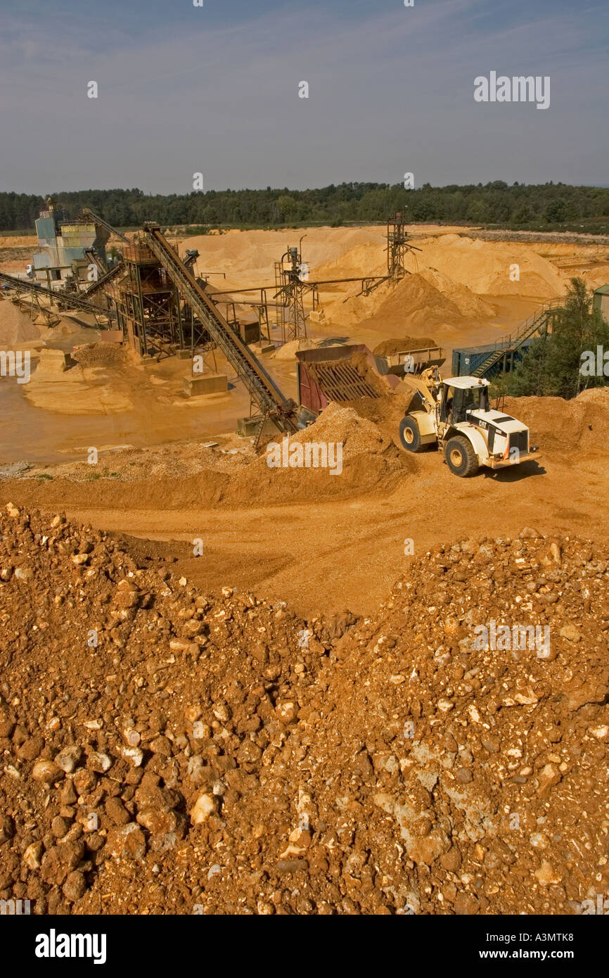 Shovel loading hopper with gravel from raw stockpile before processing ...