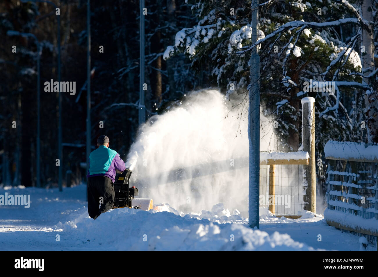 Elderly man using a small snowblower to remove the snowdrift , Finland ...