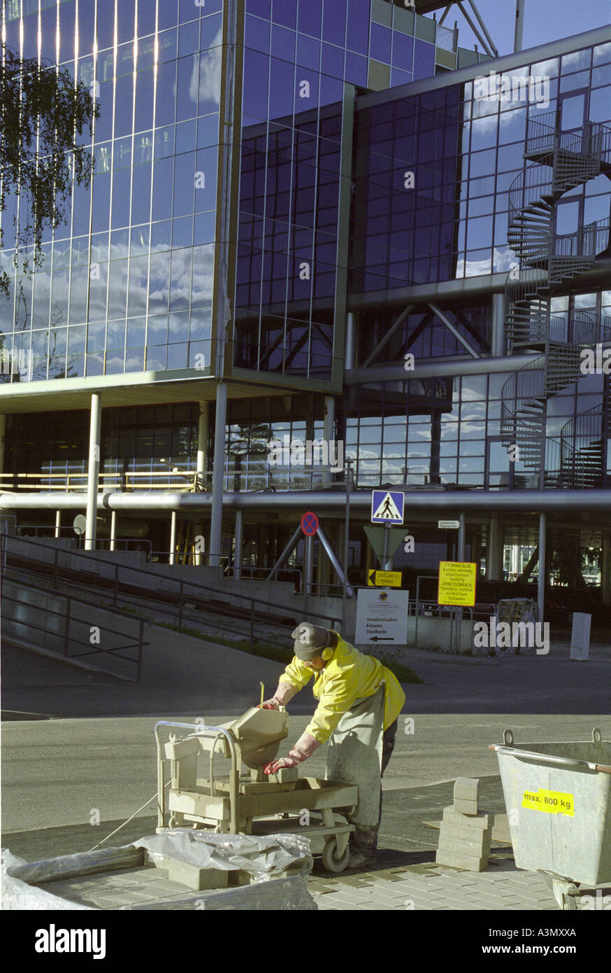 Mason laying paving stones at Helsinki airport Stock Photo - Alamy