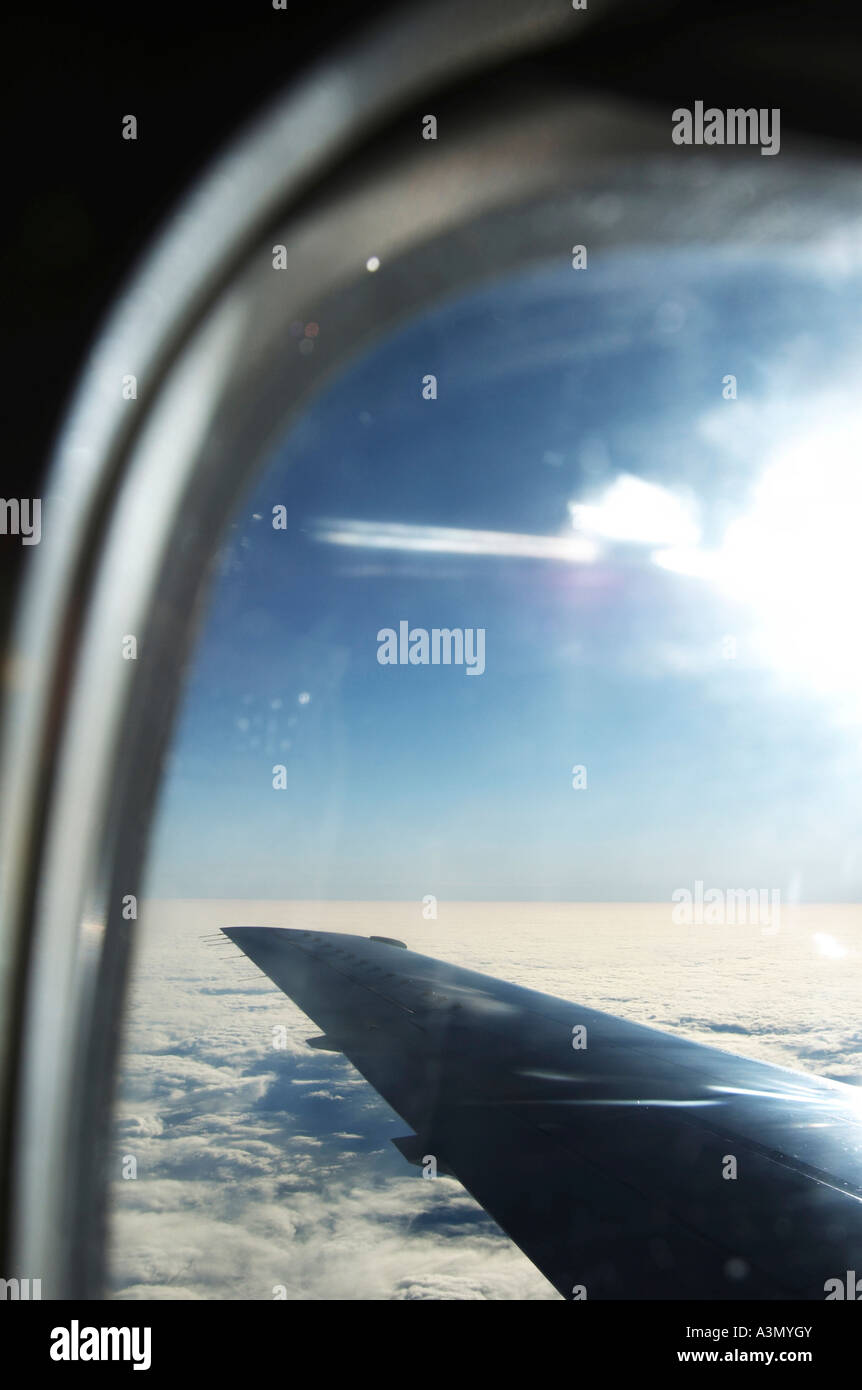 Wing of an aircraft flying above cloud Stock Photo - Alamy