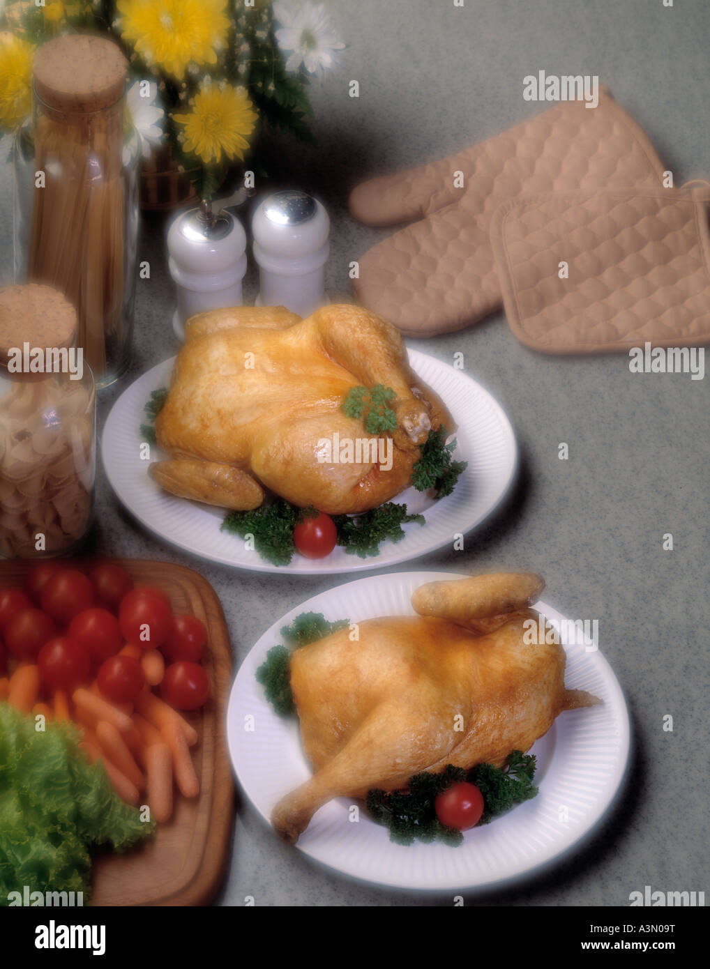 two 2 roaster broiler chickens dinner table top flowers Stock Photo - Alamy