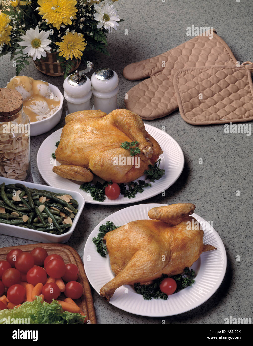 two 2 roaster broiler chickens dinner table top flowers Stock Photo - Alamy