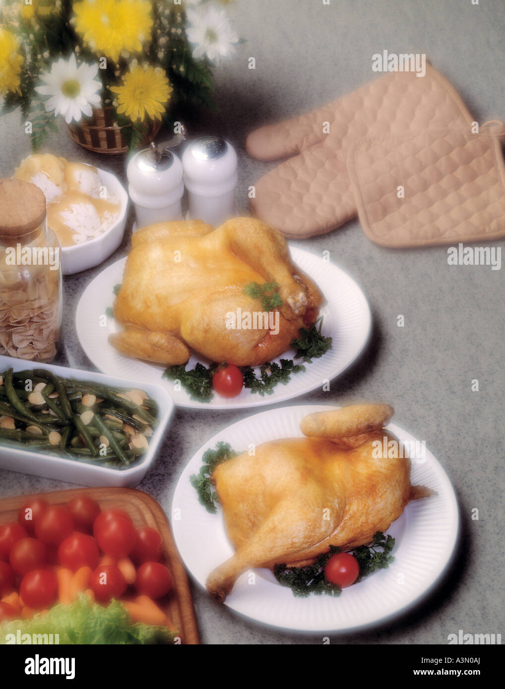 two 2 roaster broiler chickens dinner table top flowers Stock Photo - Alamy