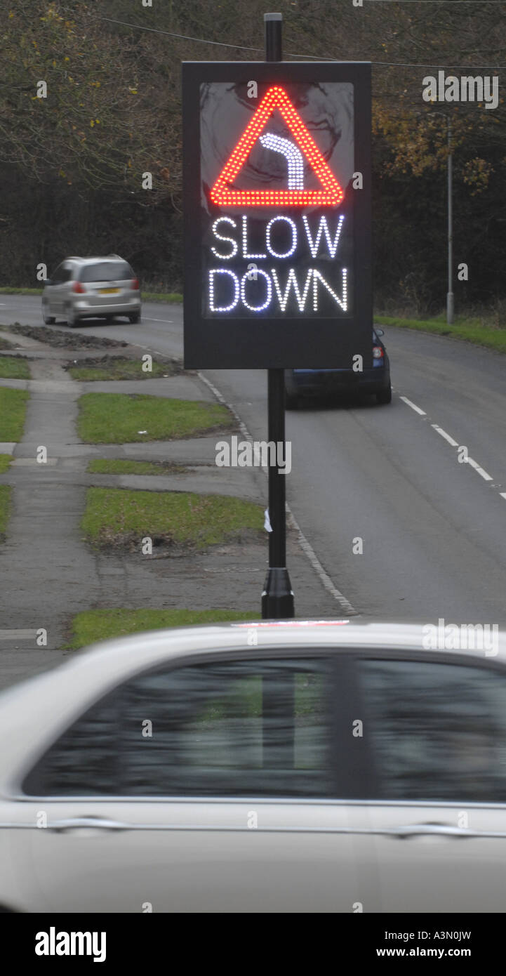Slow down sign on a bend in Worcestershire Stock Photo - Alamy