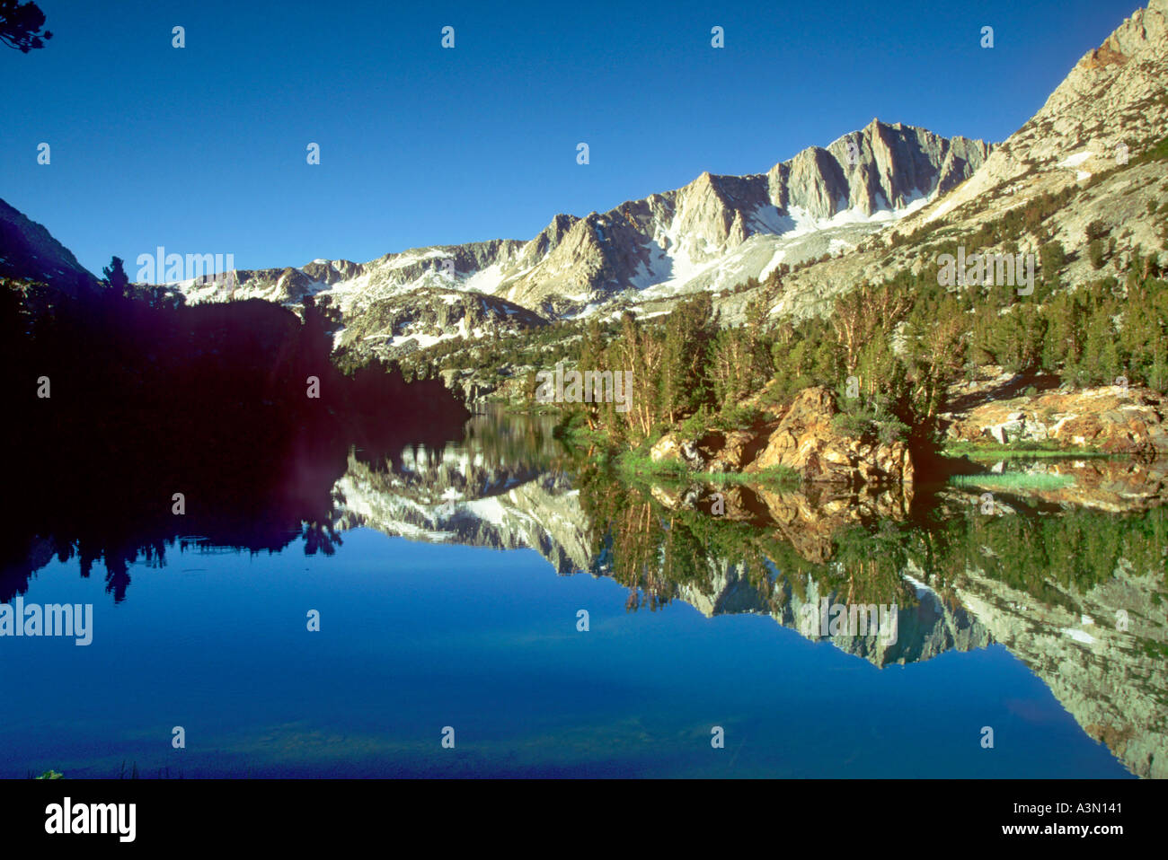 The peaks around Bishop Pass reflected in Long Lake Inyo National ...