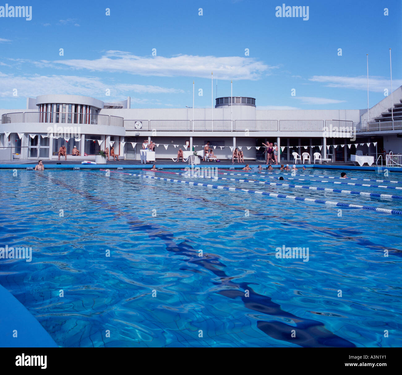 Swimmers socialising at an outdoor geothermal swimming pool in ...