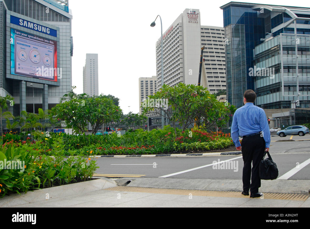 Western business man looking at Suntec City large LCD display screen ...