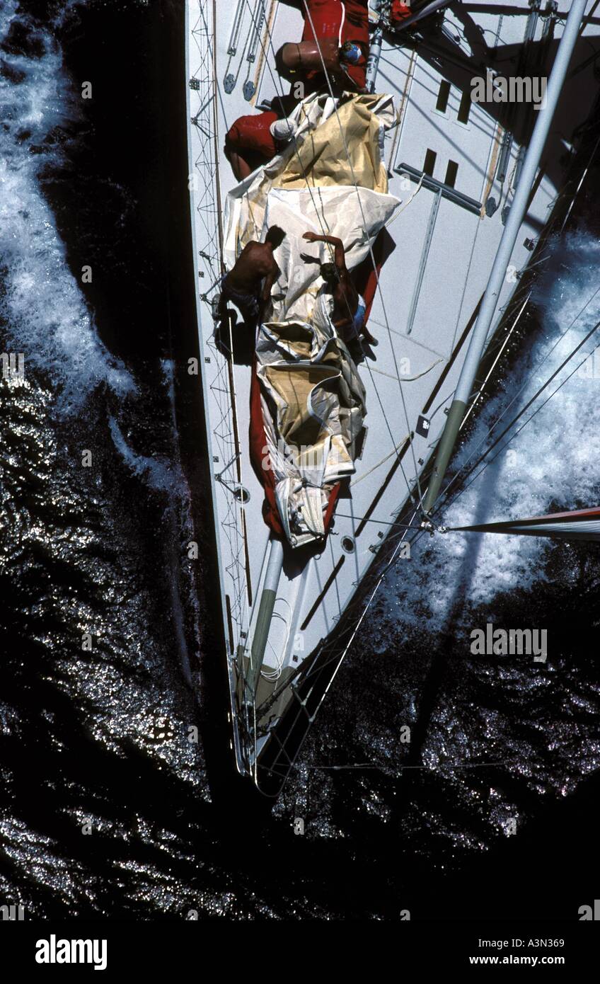 Aerial view of crew preparing sail on foredeck of racing yacht Stock ...