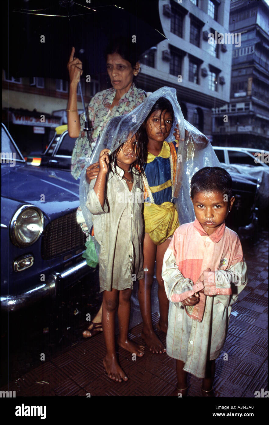 Homeless children shiver with cold in the Bombay monsoon Mubai India ...