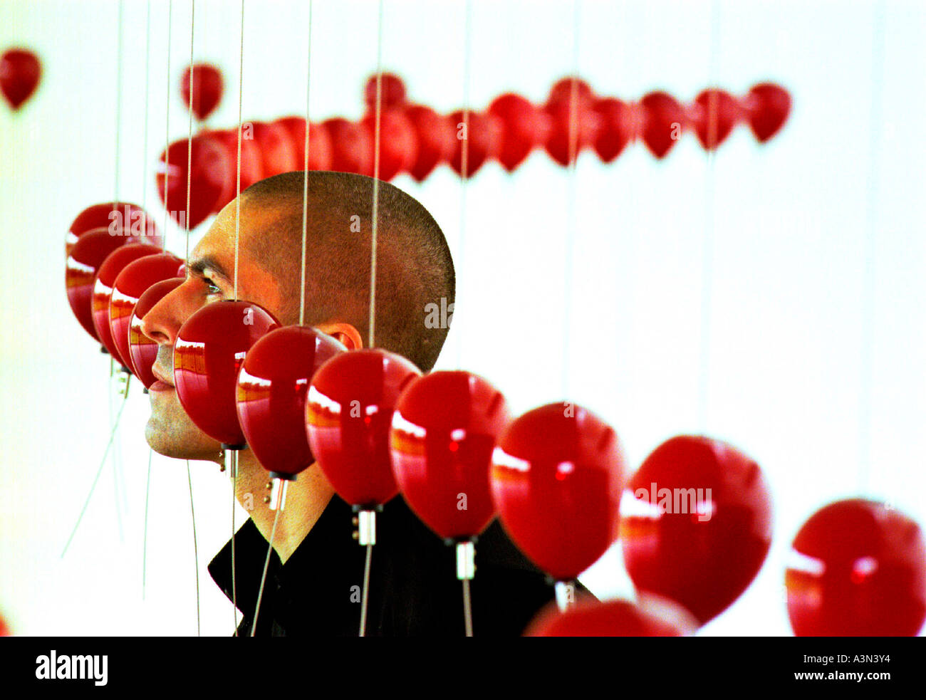 Installation Artist Michael Petry inspects some of his 144 red hand ...