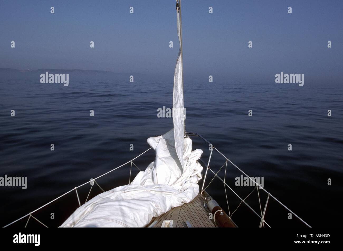 Prepared headsail ready to hoist on foredeck of Swan yacht Stock Photo ...