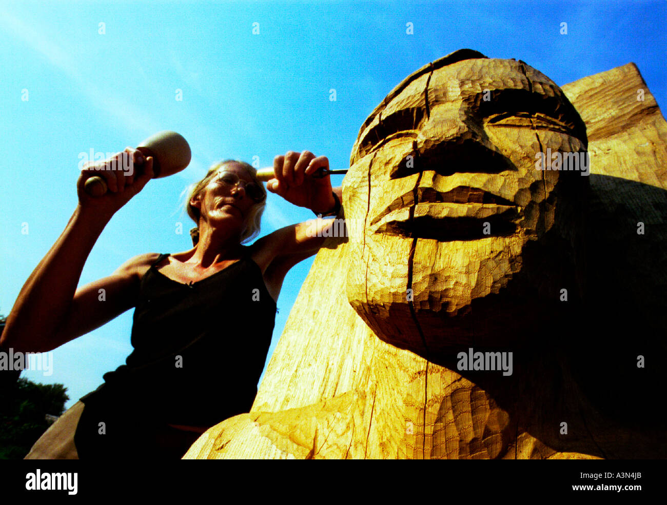 Sculptor Sue Nunn finishes the final carving on Summer Man a piece of ...