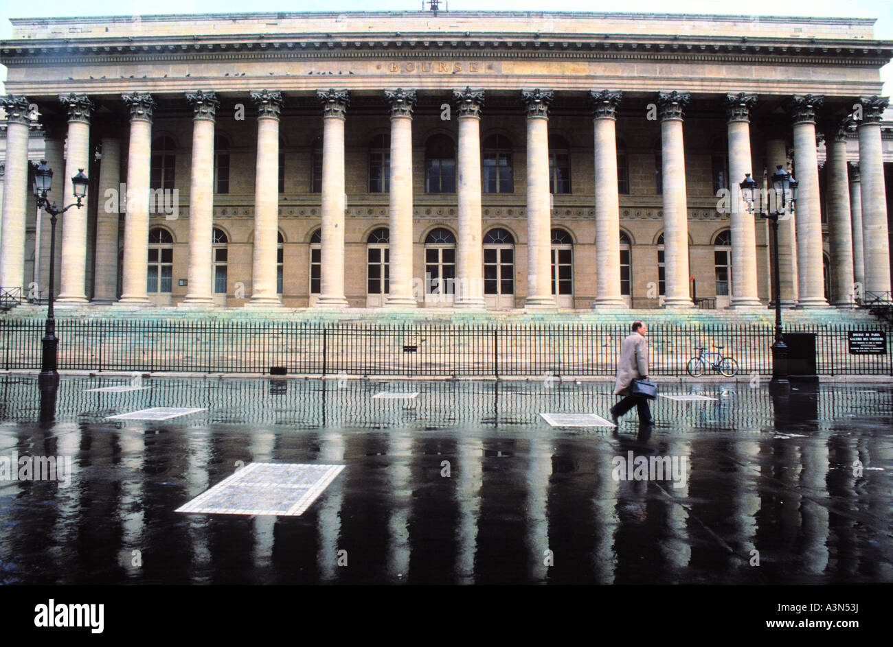 Paris Bourse, Stock Exchange, Stock Market building on a rainy day. Man ...