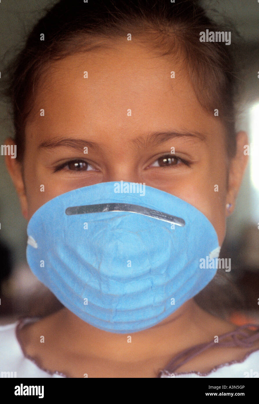 Portrait of a young girl smiling wearing a surgical mask Medical safety ...