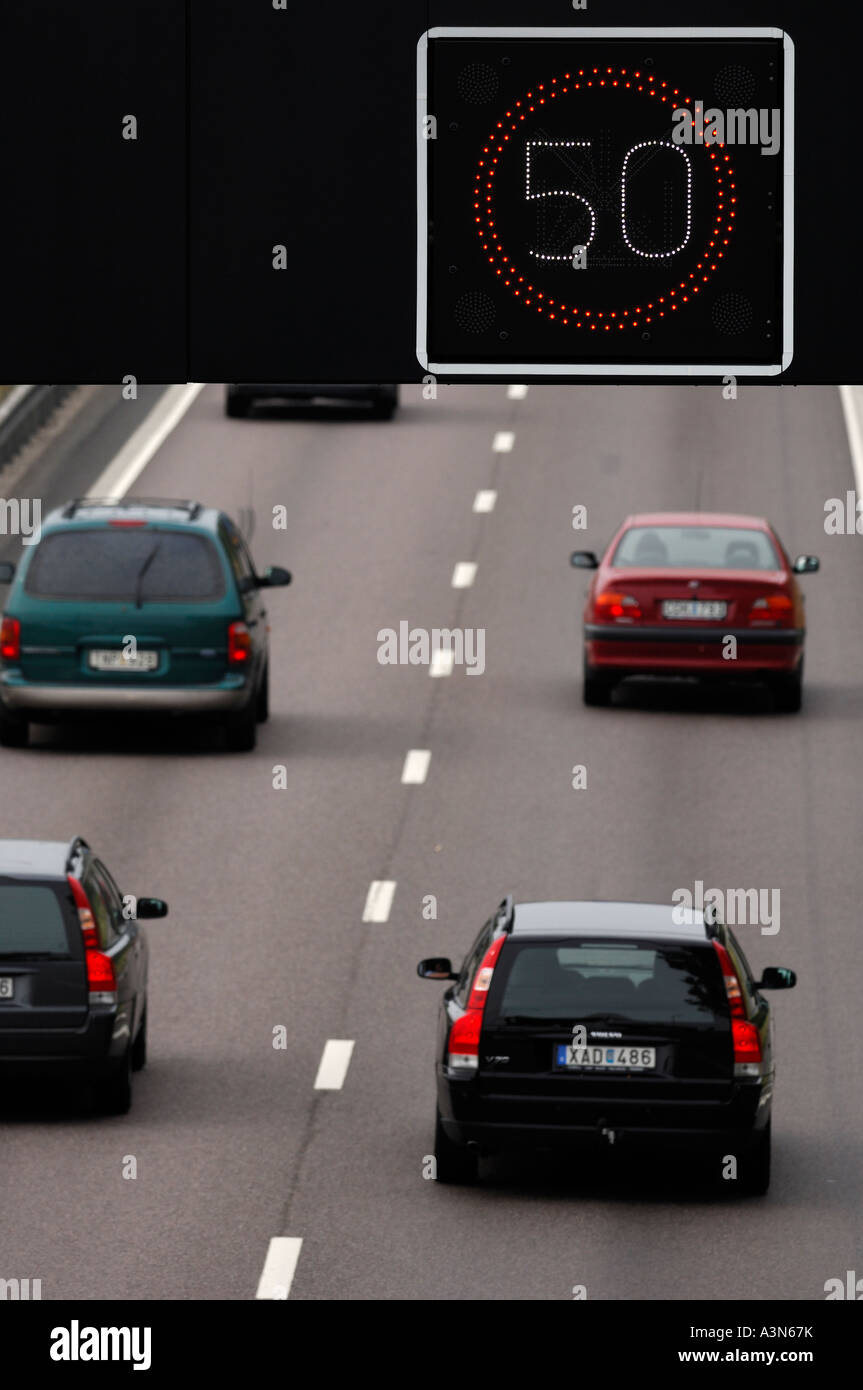 Electric signs for speed limit above a motorway Stock Photo - Alamy